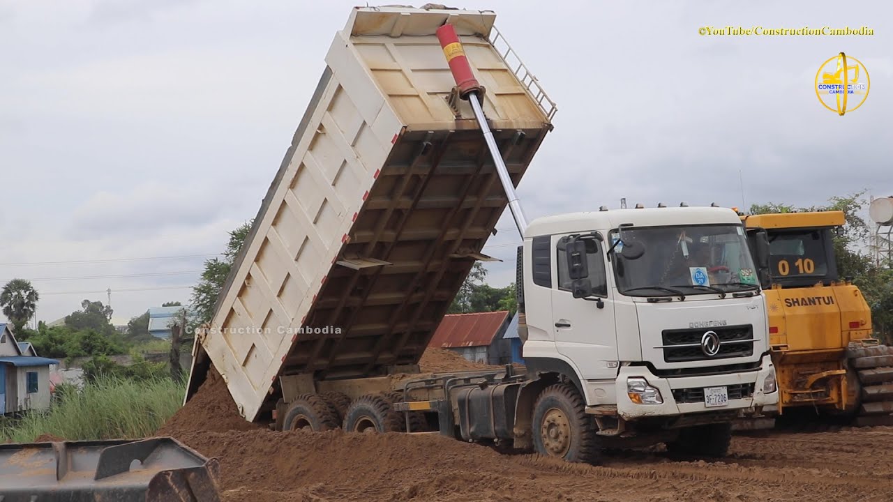 Dongfeng dump truck dumping sand And SHANTUI Dozer Pushing Sand Work in ...