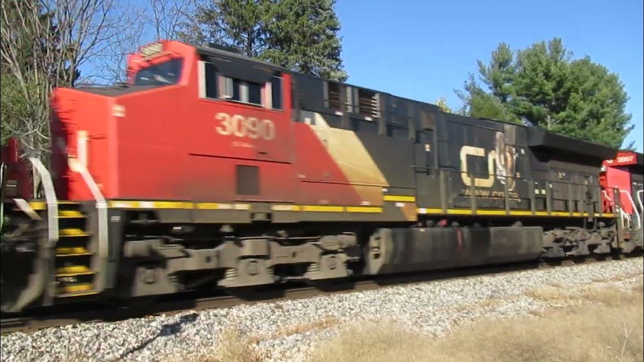 CN 3907, 3090 pull an Eastbound freight train with PRESSURAIDE hoppers past Vicksburg, Michigan ...
