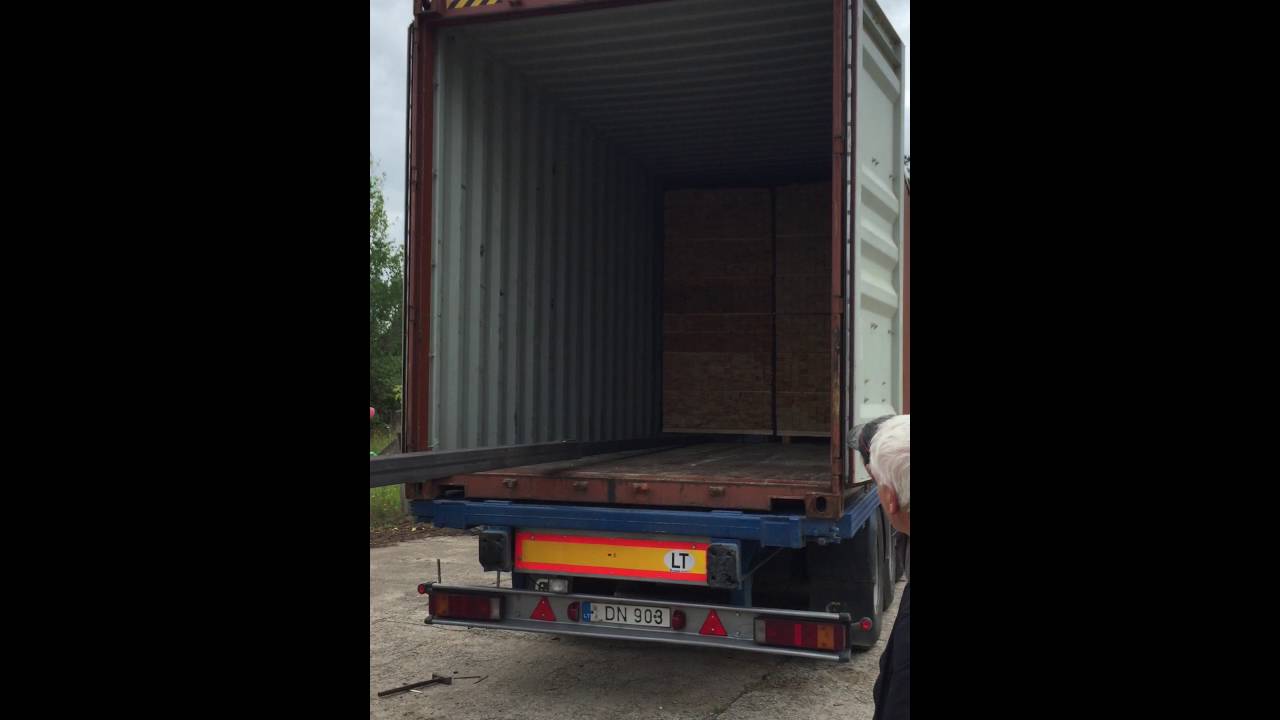 Loading lumber in container - YouTube