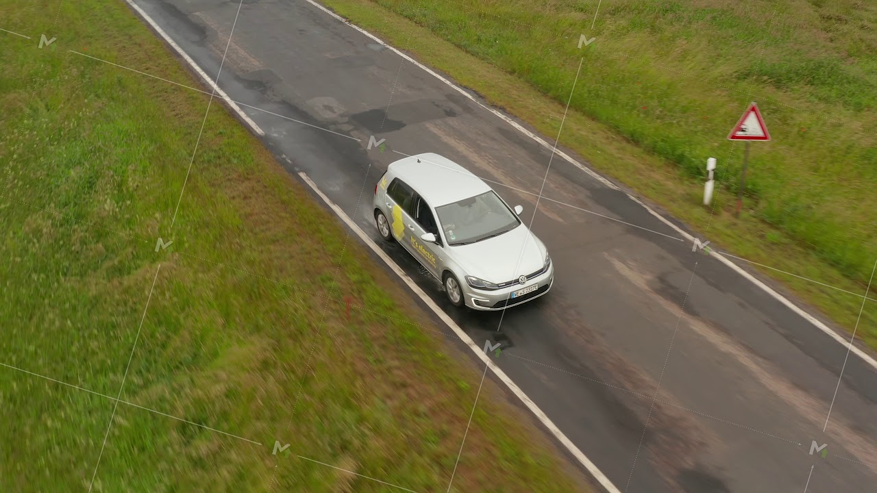 Close up follow aerial of Electric Vehicle driving over road in German ...