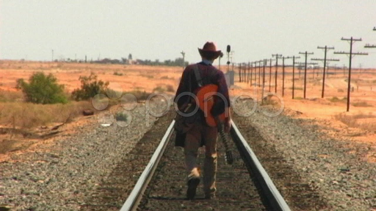 Cowboy Walks Railroad Tracks Away From Camera. Stock Footage - YouTube