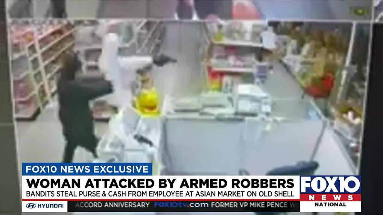 Surveillance footage shows woman robbed by armed suspects - YouTube