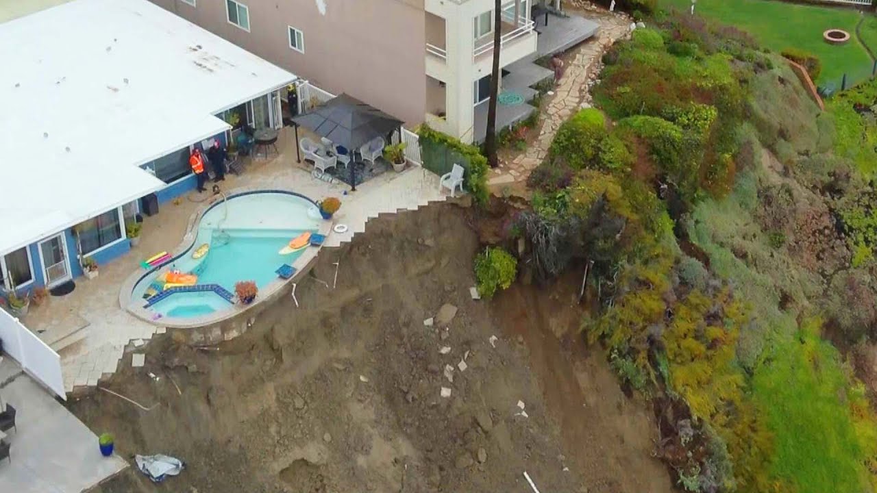 Pool Narrowly Escapes Falling Down Bluff During Landslide - YouTube