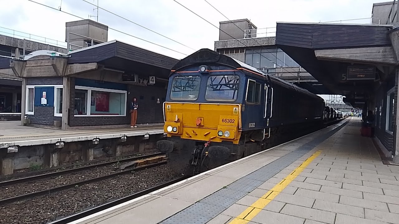 6X43 ex DRS class 66 302 passes Stafford platform 5 with car train to ...