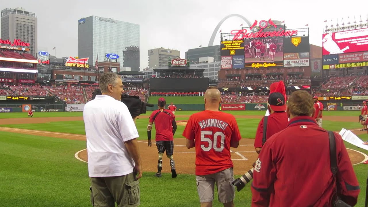 Corporal Todd Nicely throws out a first pitch on behalf of yp at the ...