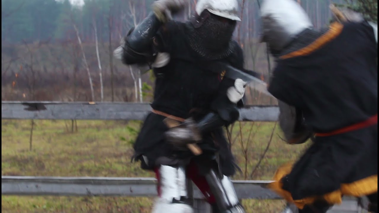 Two strong knights in steel armor hitting each other with swords, slow ...