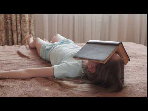 Face sleeping girl covered opened book in home bedroom. Young girl lying on bed with opened book on