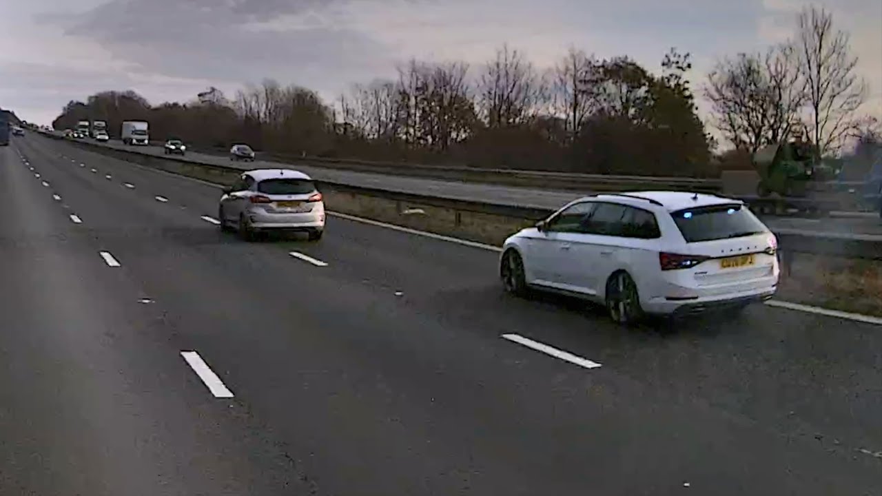 Ford Fiesta pulls out in front of police car with blue lights flashing ...
