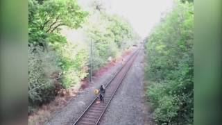 EXTRAORDINARY MOMENT HERO RAIL WORKER RISKS LIFE TO SAVE 'DRUNK' CYCLIST AS TRAIN APPROACH - YouTube