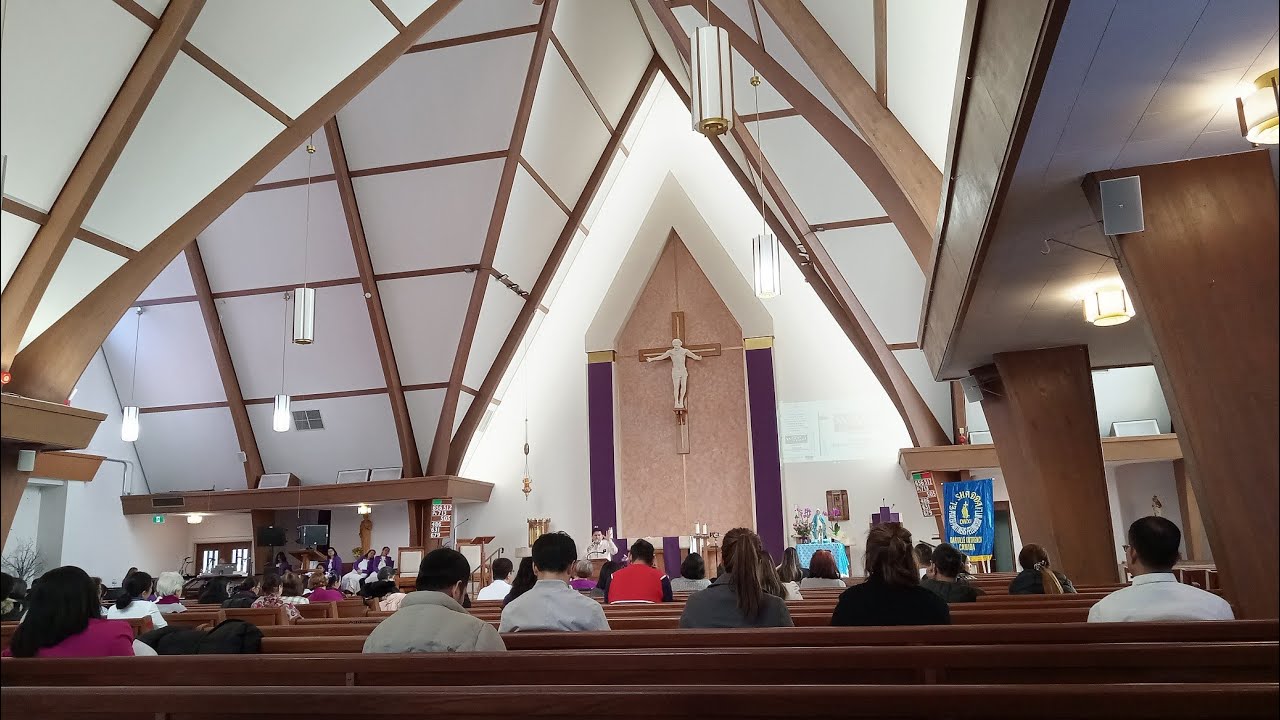 Parents and kids offering flowers to Mother Mary before Holy mass at St ...