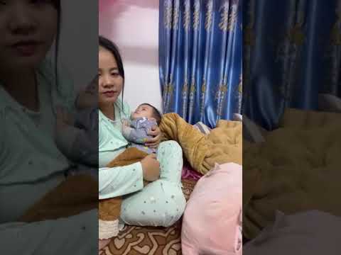BREASTFEEDING BABY BY BEAUTIFUL MOTHER.
