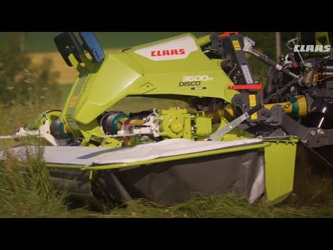 CLAAS DISCO MOVE disc mower harvesting grass. Dancing cows, move it ...