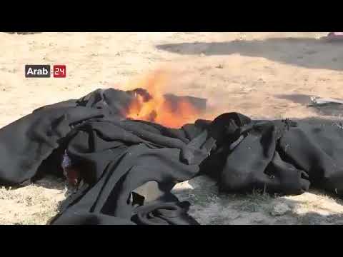 Yazidi woman burns her niqab after being freed from ISIS.