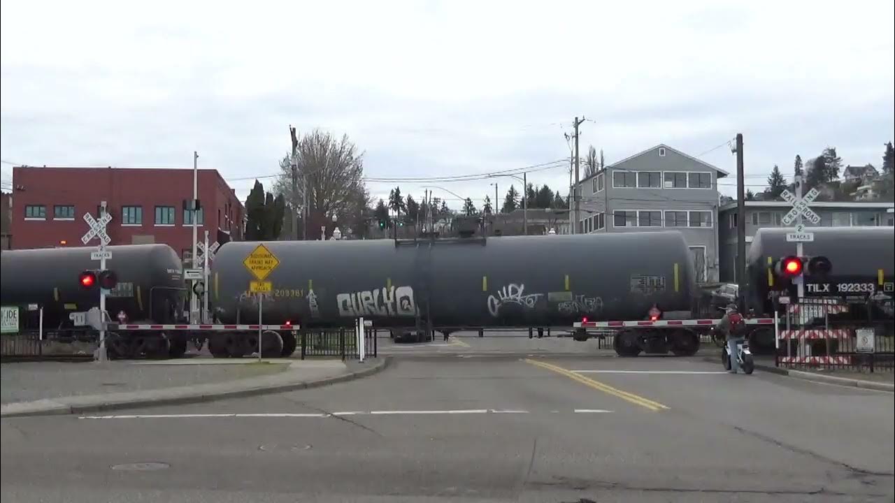 (Southbound) BNSF Mixed Freight Train passes through the McCarver Street Railroad Crossing ...