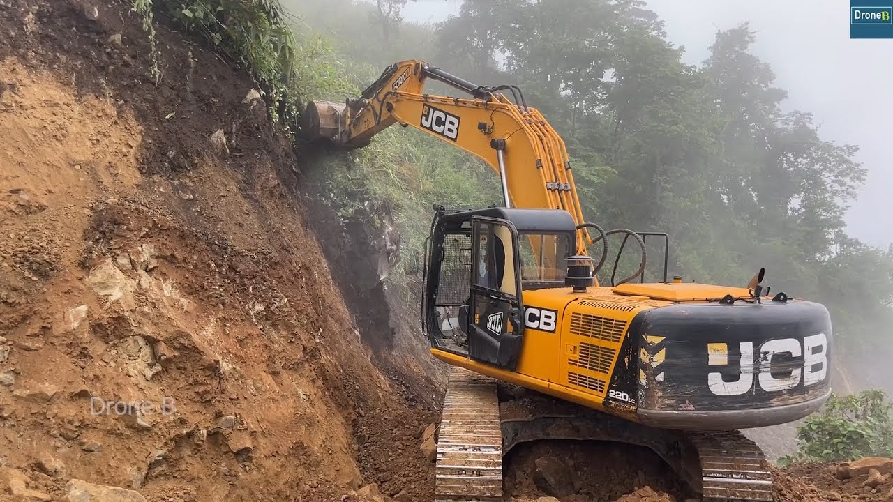Cutting Hillside and Lowering Down Road Bed-Excavators Giving Final ...