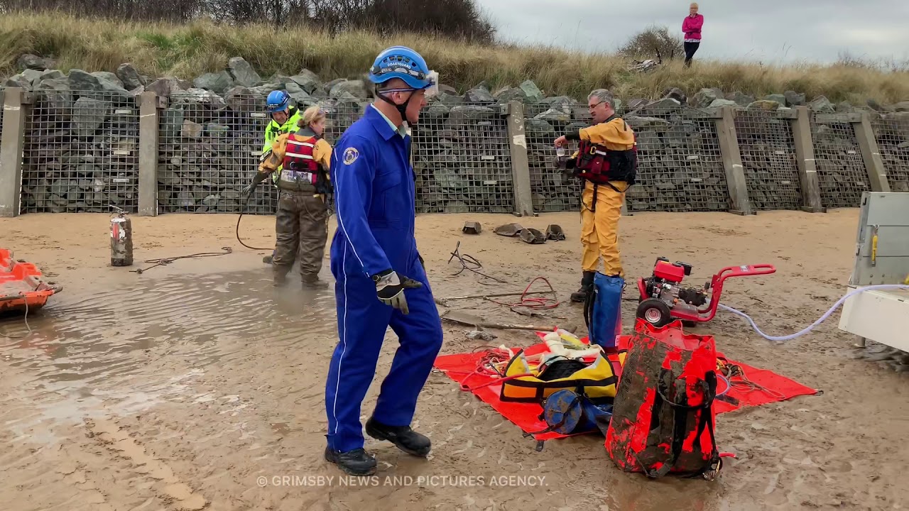 Mud rescue teams clean down after rescue. - YouTube