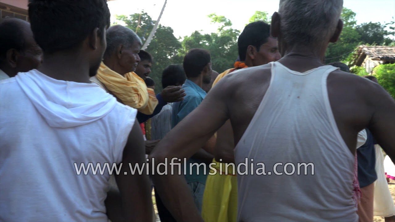 Devotees playing musical instruments and chanting in a religious ritual ...