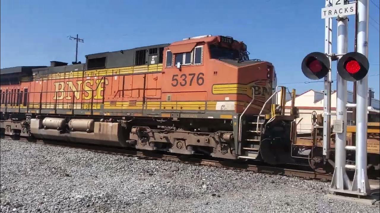 BNSF intermodal train back to back with Amtrak California San Joaquin train 713 Fresno ca - YouTube