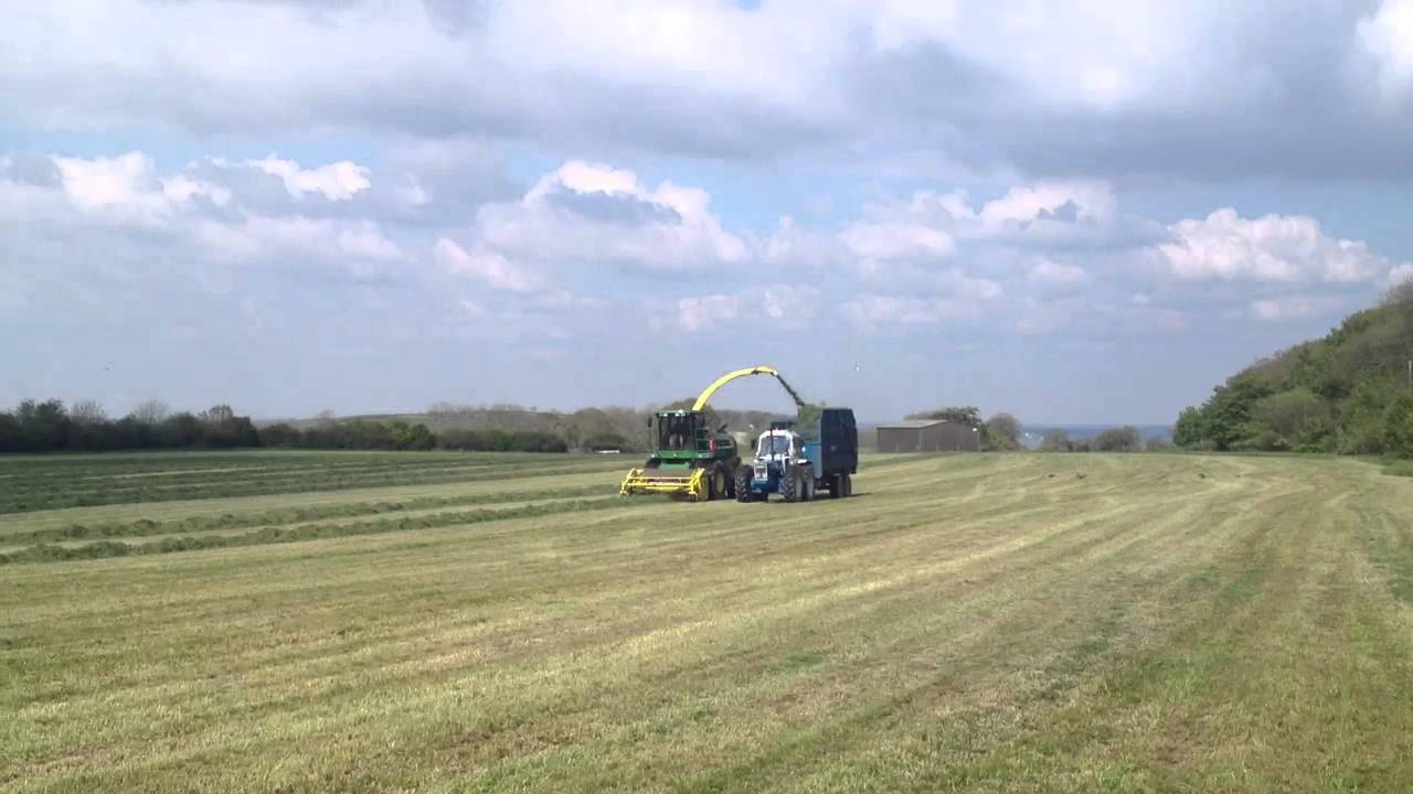 John Deere forager and County tractor hard at work - YouTube