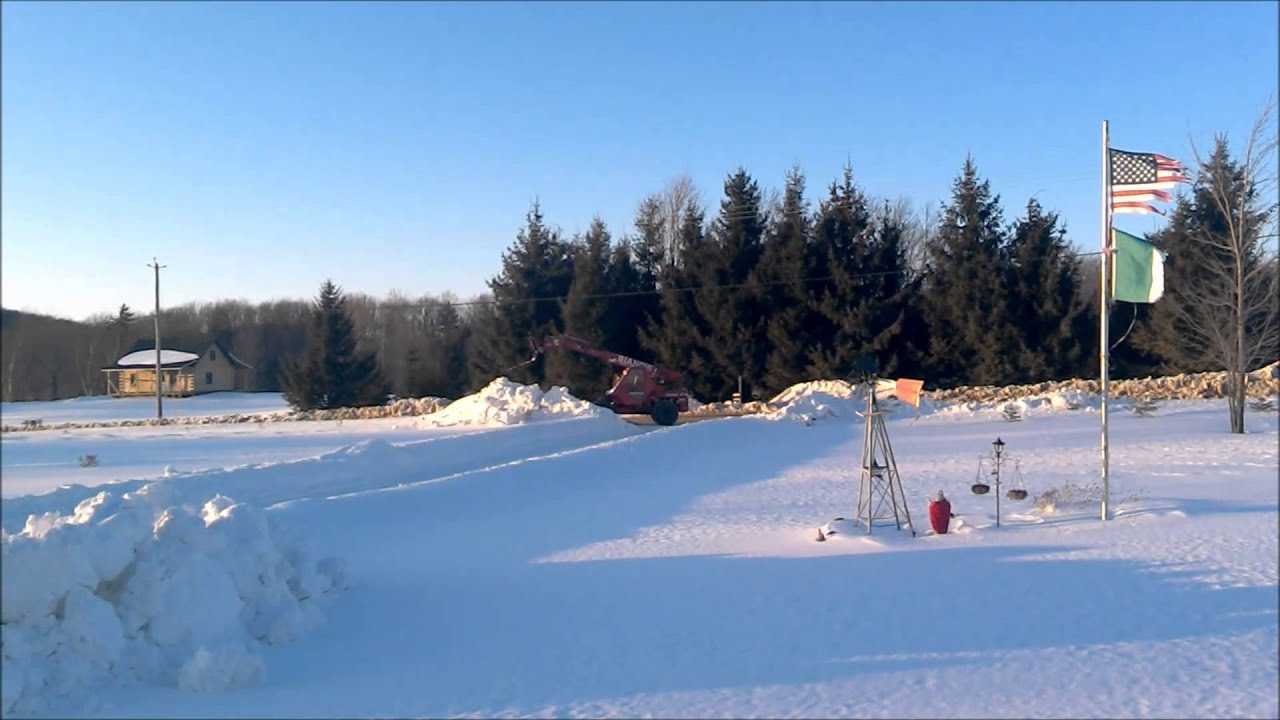 Pushing back snow banks with the Skytrak 5522 - YouTube