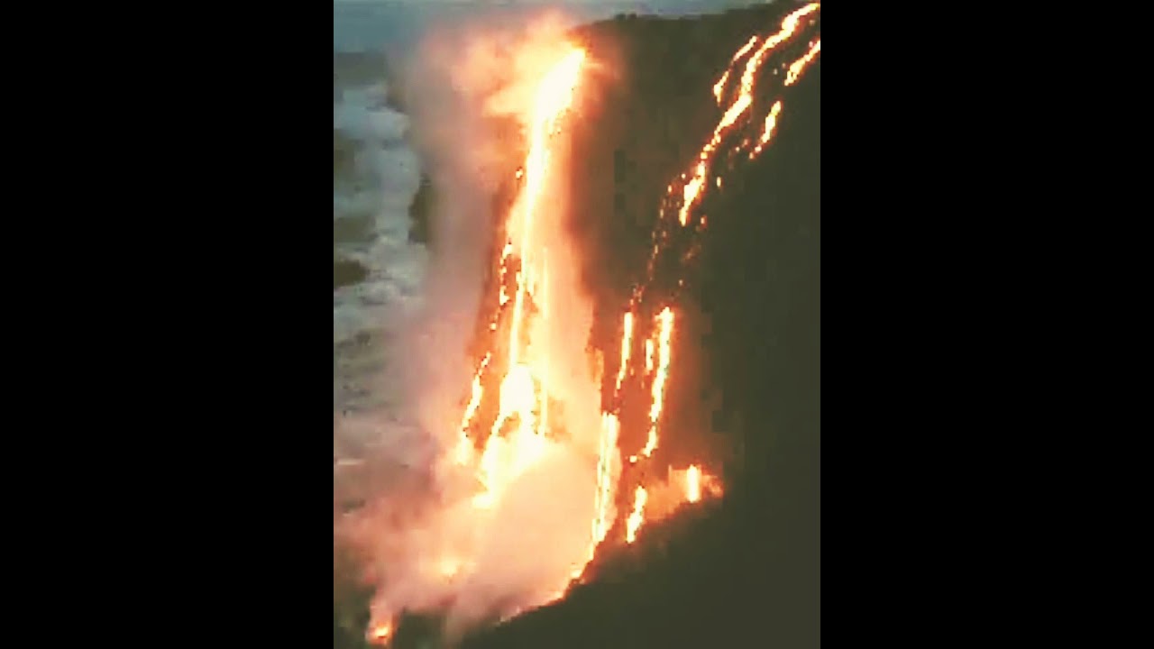Lava falling over Sea cliff . Lava dropping into the sea. Latest ...