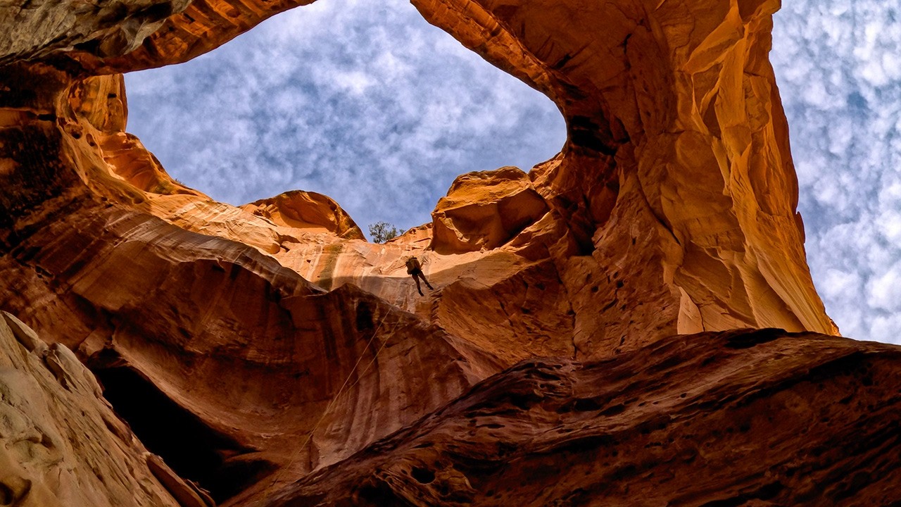 Rappelling through arches - Cassidy Arch, Capitol Reef National Park ...