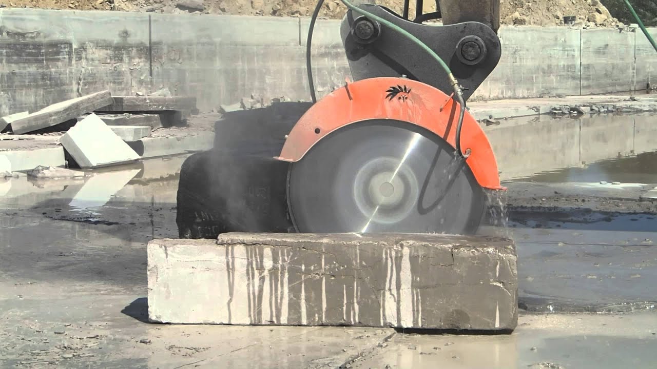 Hydraulic excavator rocksaw cutting limestone in Owen Sound, Ontario ...