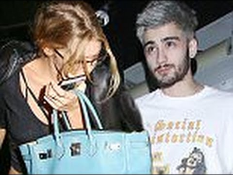 Gigi concealed her face behind her thick blonde tresses, her taut tummy was instantly recognisable