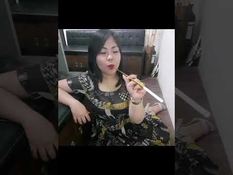 Smoking with a long holder.