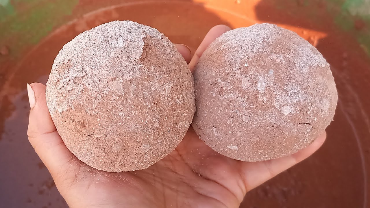Red brick dirt balls smashing in foamy water - YouTube