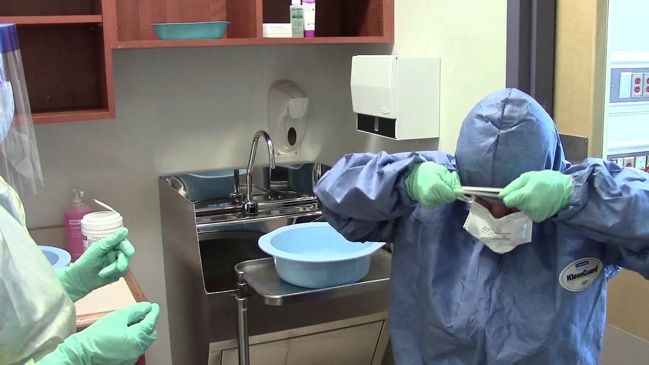 Taking off EVD Personal Protective Equipment before leaving isolation ...