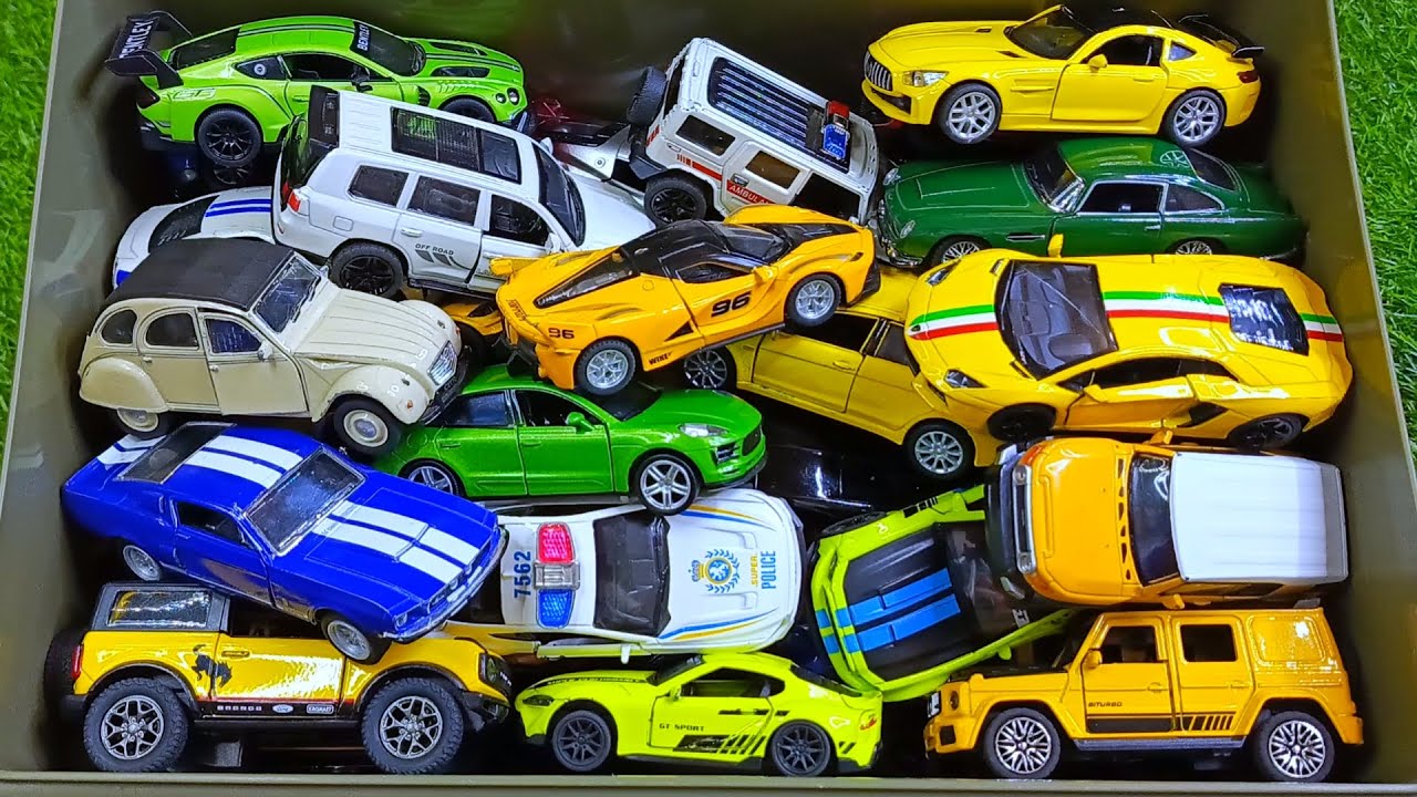 Box full of various miniature cars Peugeot, Jaguar, Pagani, Hyundai ...