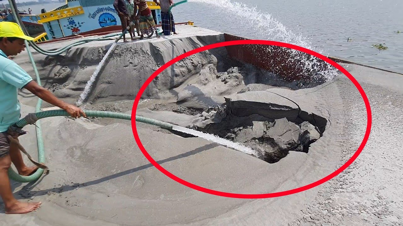 Sand is being unloaded from large ships with powerful dredger machines ...