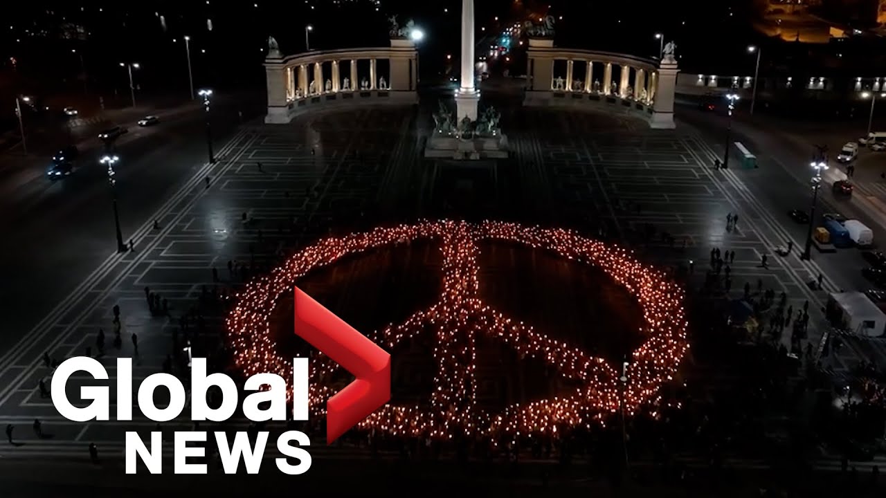 Hundreds form peace sign at candlelight vigil in Budapest in solidarity ...