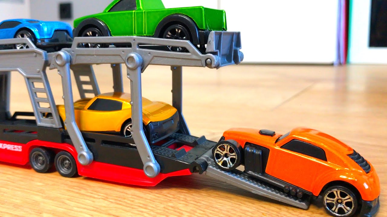 Small diecast model cars being carried by transportation vehicles - YouTube