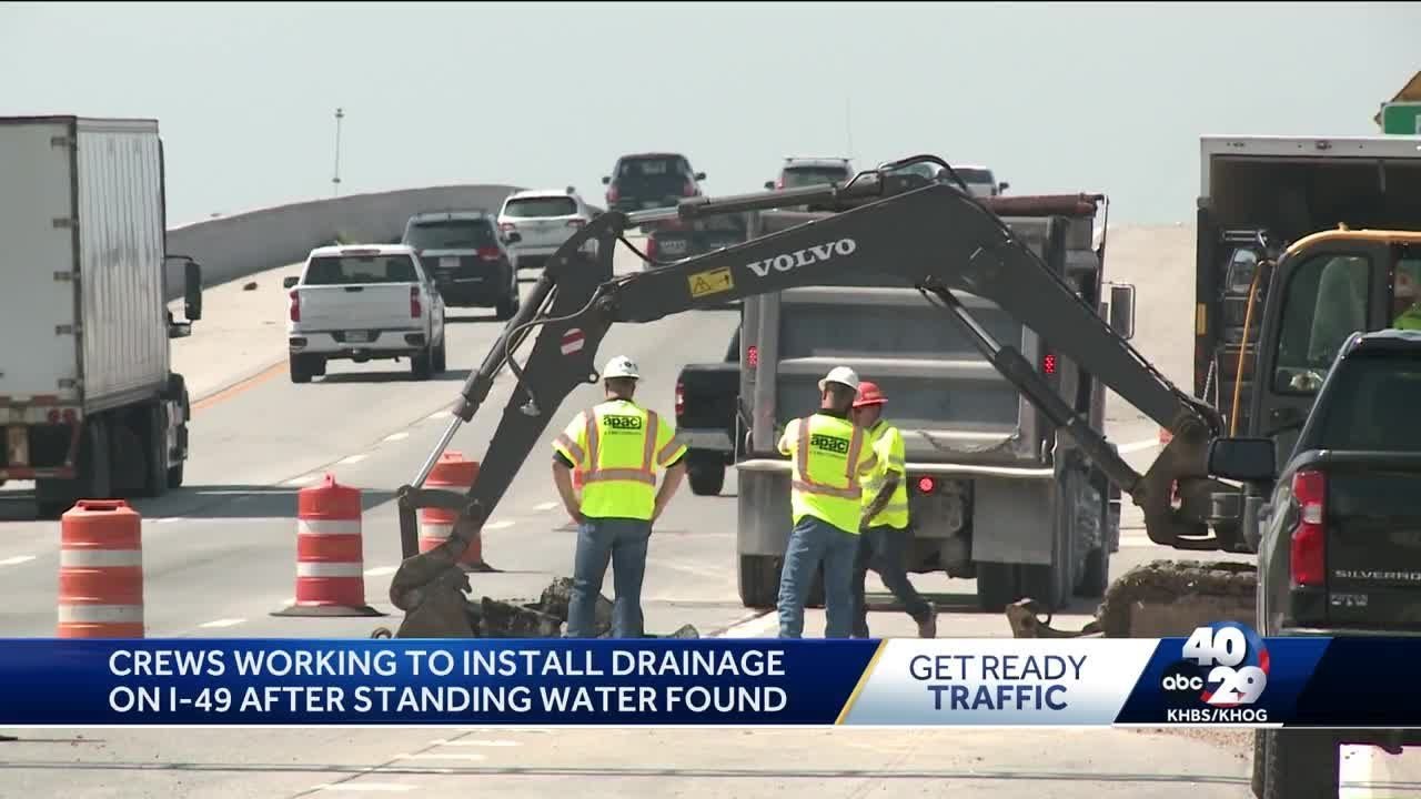 Contractors close I-49 exit after groundwater seeps into asphalt - YouTube