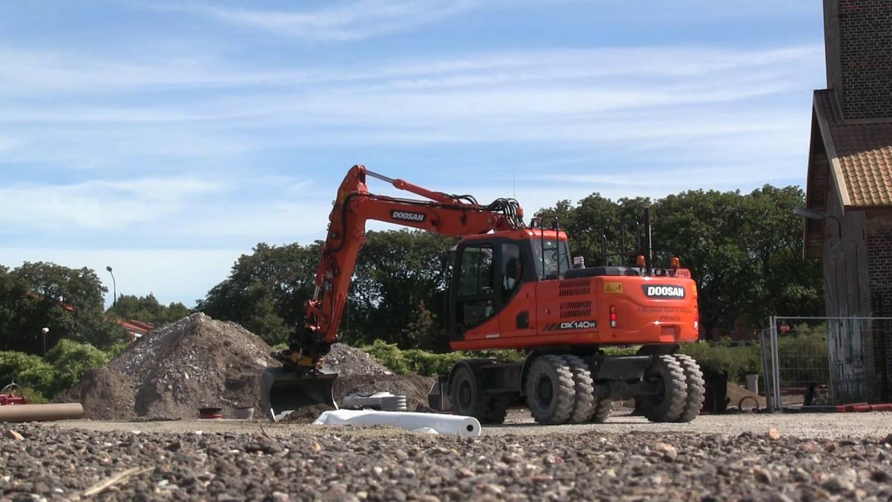 Doosan DX140W(iT4) Wheeled Excavator at work - YouTube
