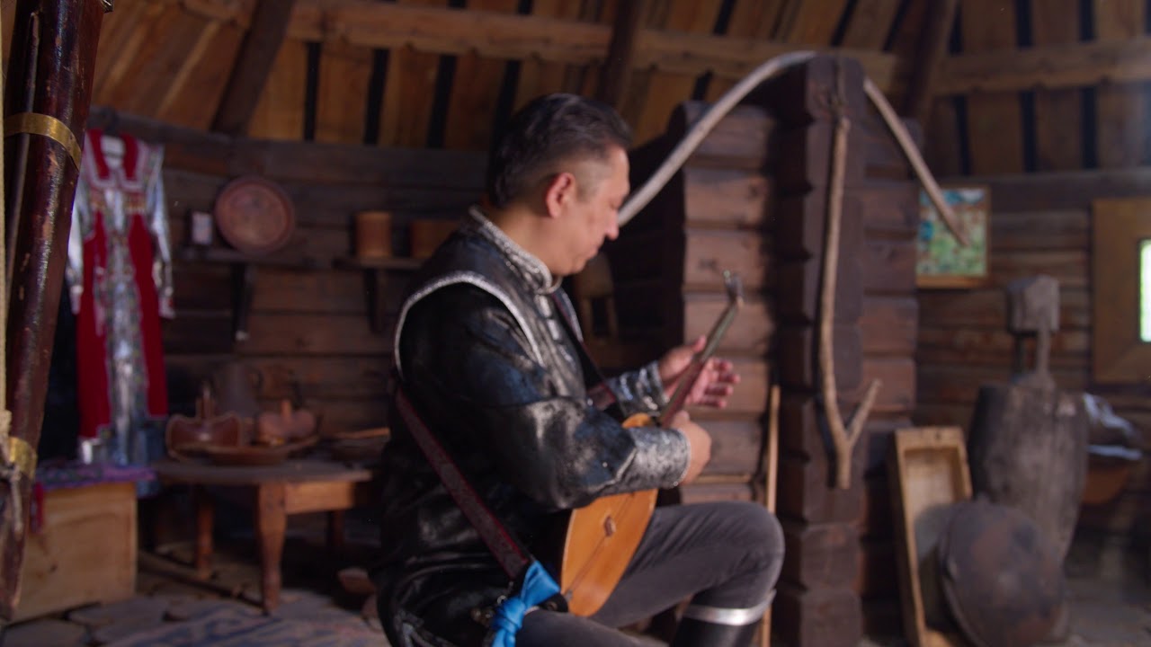 Musician playing traditional musical instrument. Bridle, gun, bag in ...