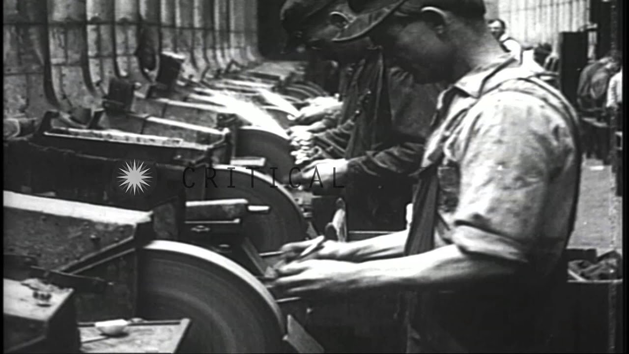 Workers at machinery manufacture rifles in a factory in the United ...