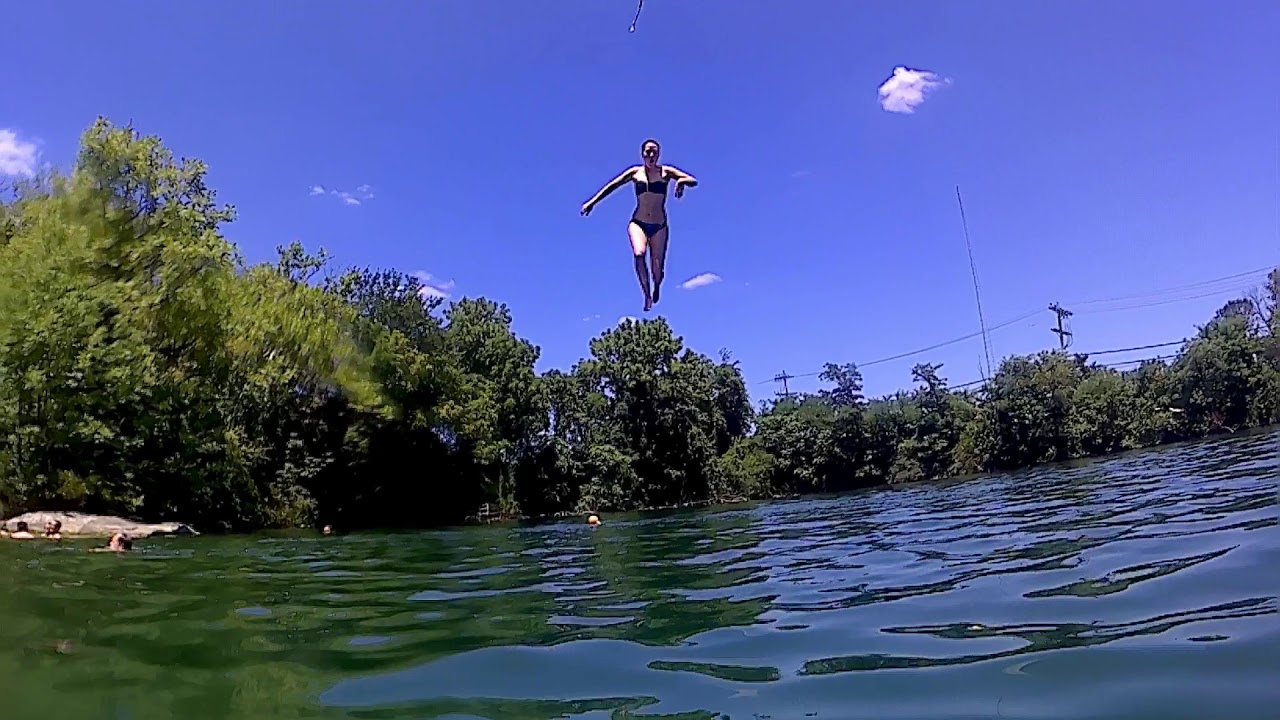 Girl rope swing into lake in slow motion - YouTube
