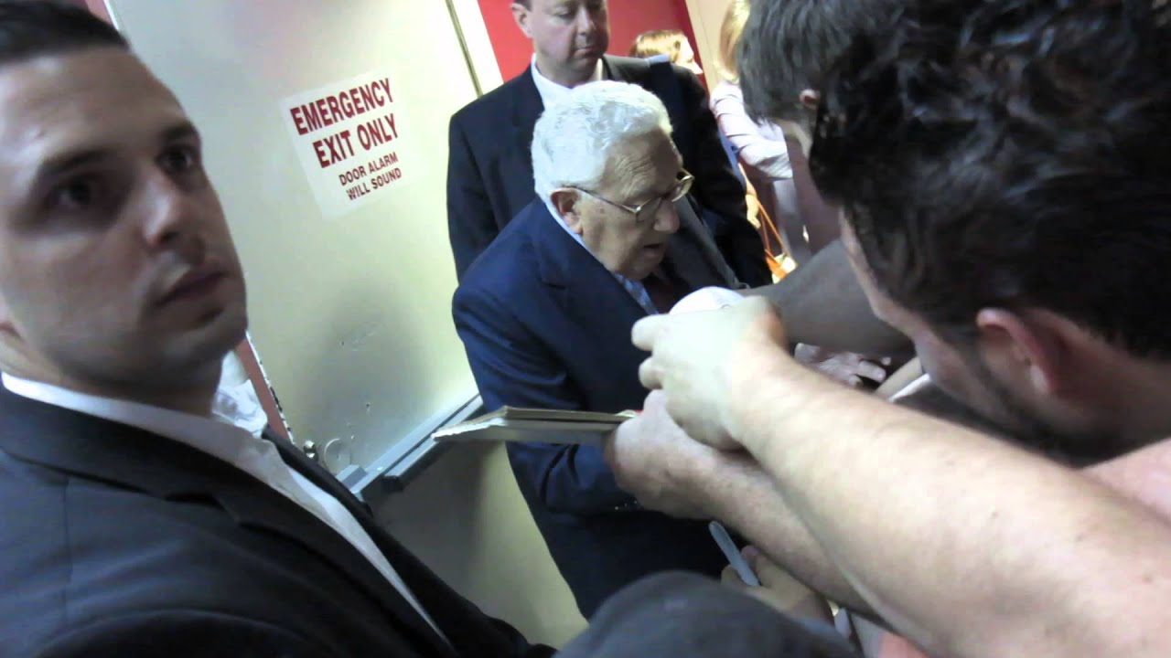 Secretary of State Henry Kissinger signing autogaphs at Colbert Report ...