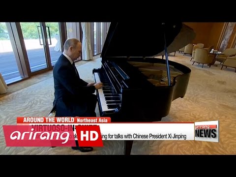 Putin plays piano as he awaits Chinese President Xi