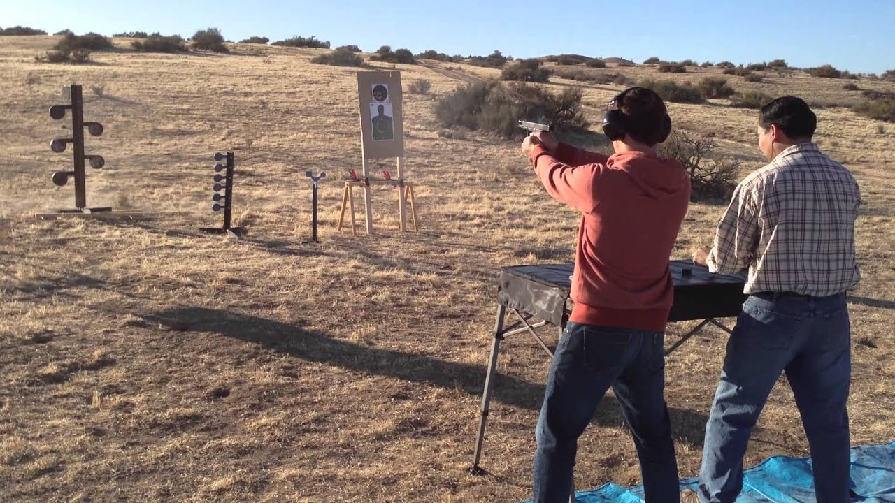 Shooting 9mm handguns at a dueling tree - YouTube
