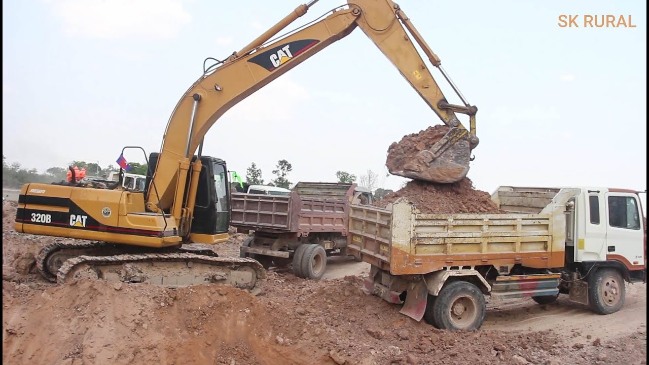 Excavator Loading Land On Trucks - CATERPILLAR 320B - YouTube