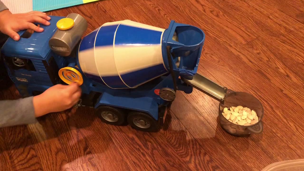 Playing Vtech Exxcavator and Bruder Mixer trucks with pumpkin seeds ...