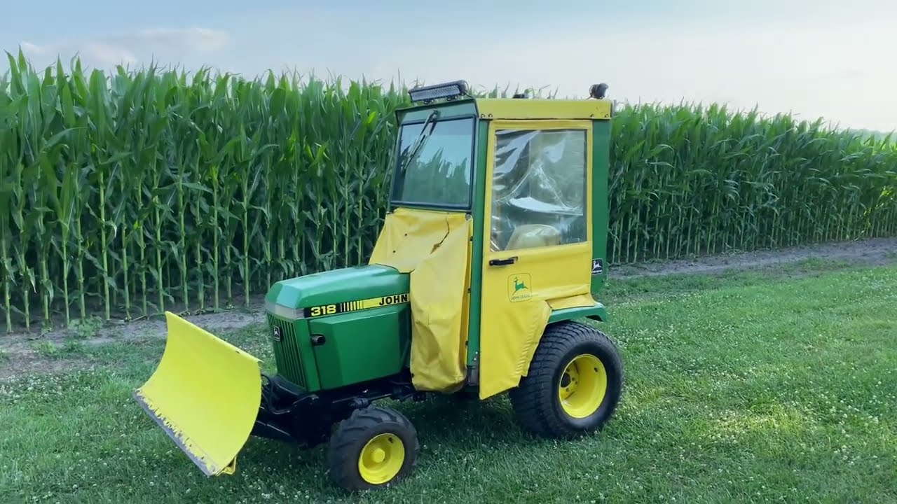 John Deere 318 with blade and snow cab - YouTube