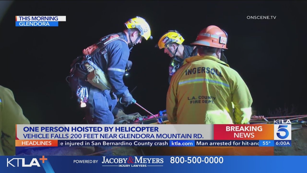 Driver hoisted after car plummets 200 feet down hillside - YouTube
