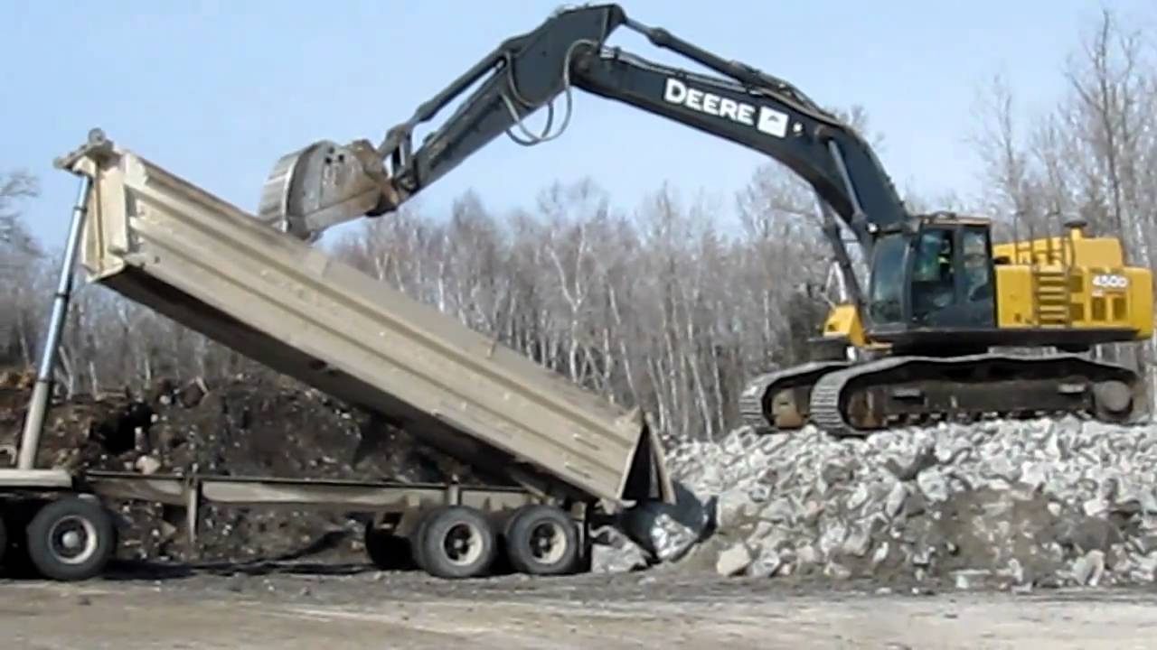 Unloading 4 foot rip rap to beef up the Diversion Dam - YouTube