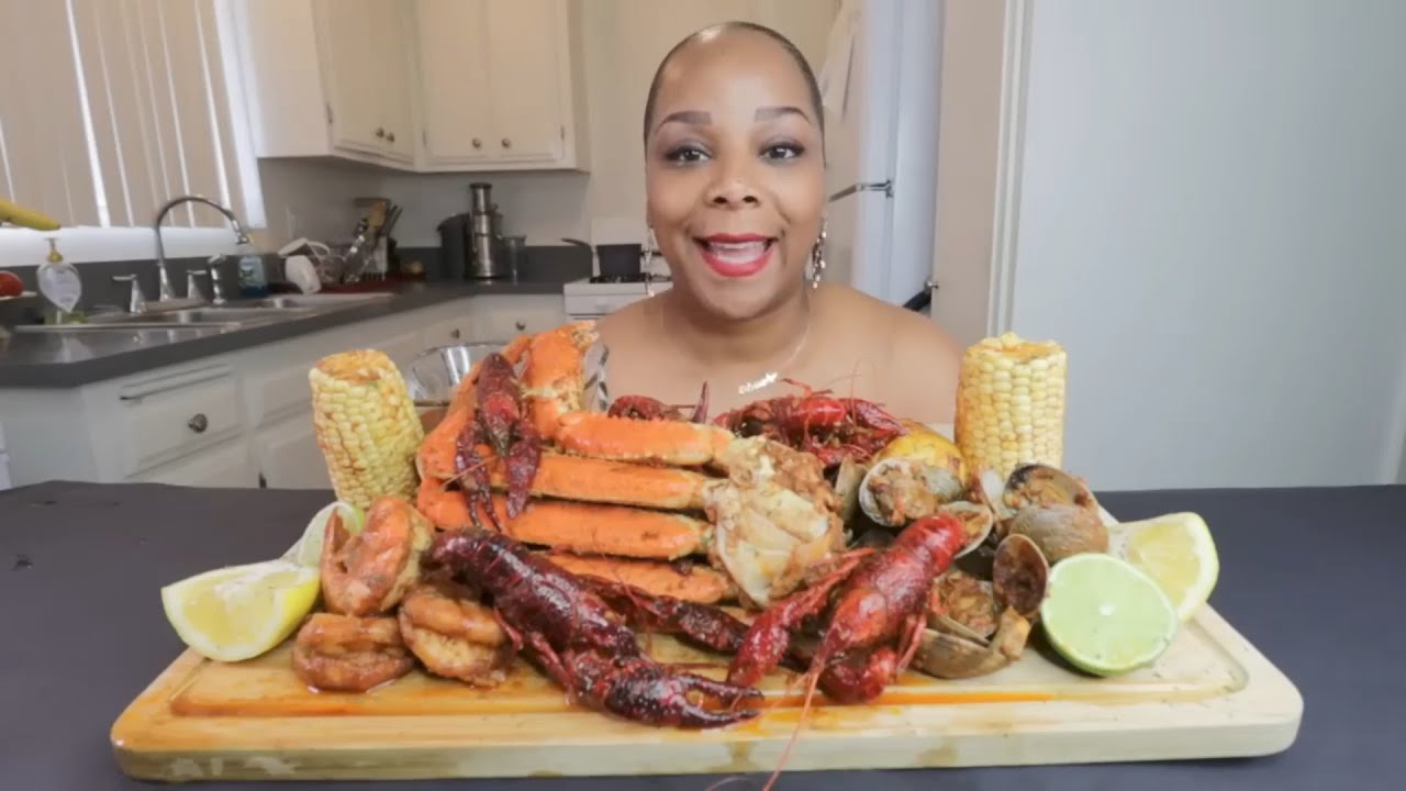 CRAB LEGS + CRAWFISH + GIANT SHRIMP DRENCHED IN SEAFOOD SAUCE!! - YouTube