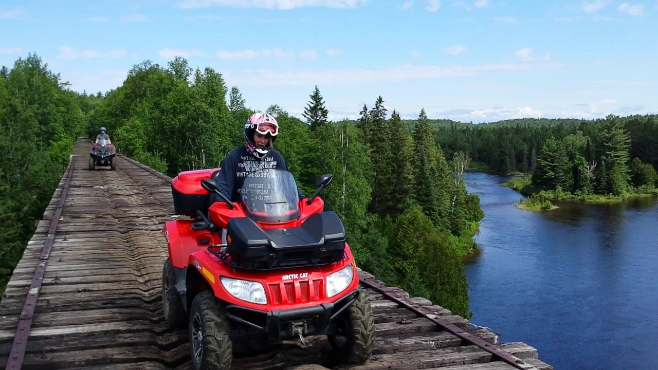 Crossing with ATVs old train railbed bridge over the Wanapitei River ...